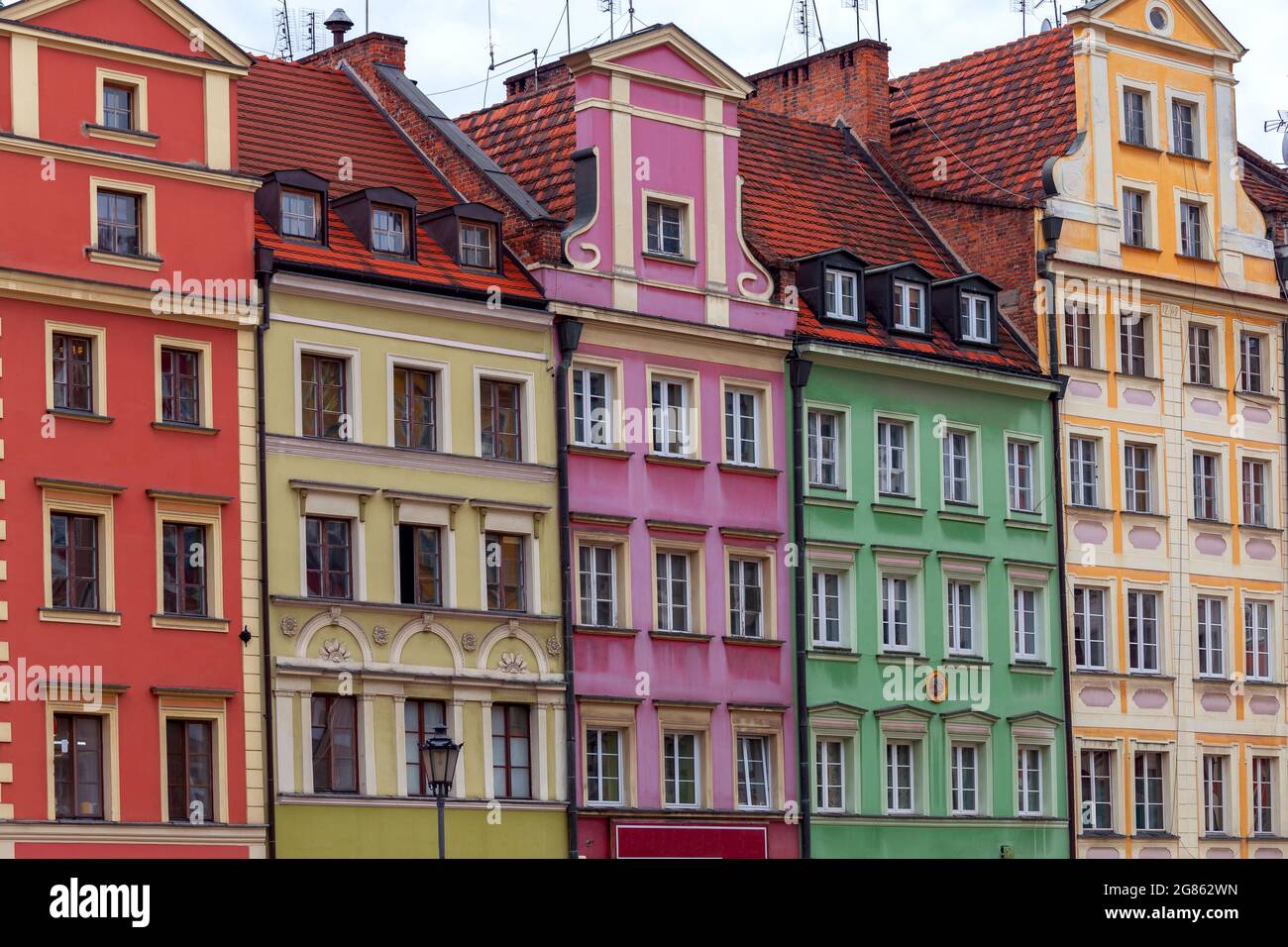 Multi-colored facades of medieval houses on the town hall square ...