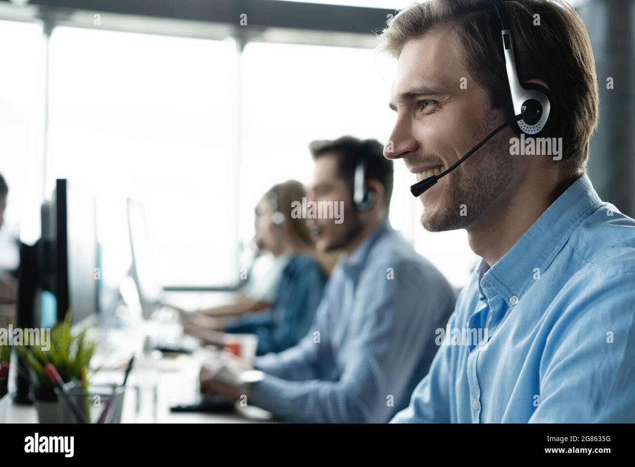 Young handsome male customer support phone operator with headset ...