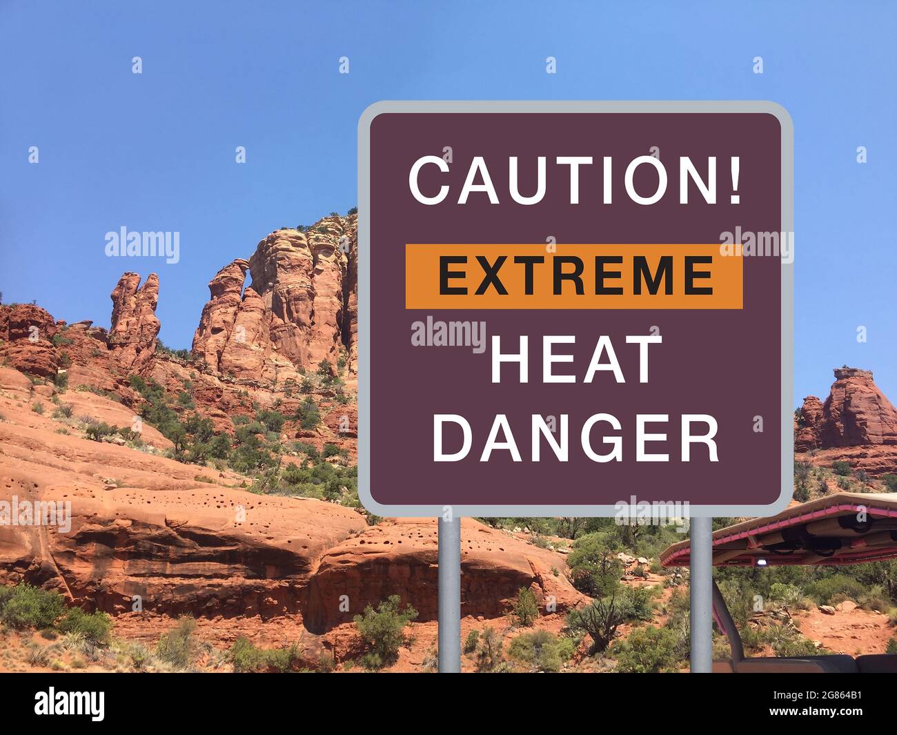 Large road warning sign saying CAUTION! EXTREME HEAT DANGER with stone ...