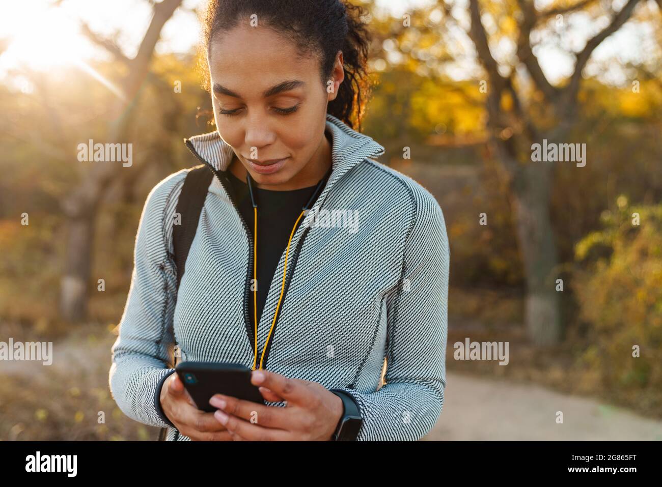 Happy girl walking using phone hi-res stock photography and images - Alamy