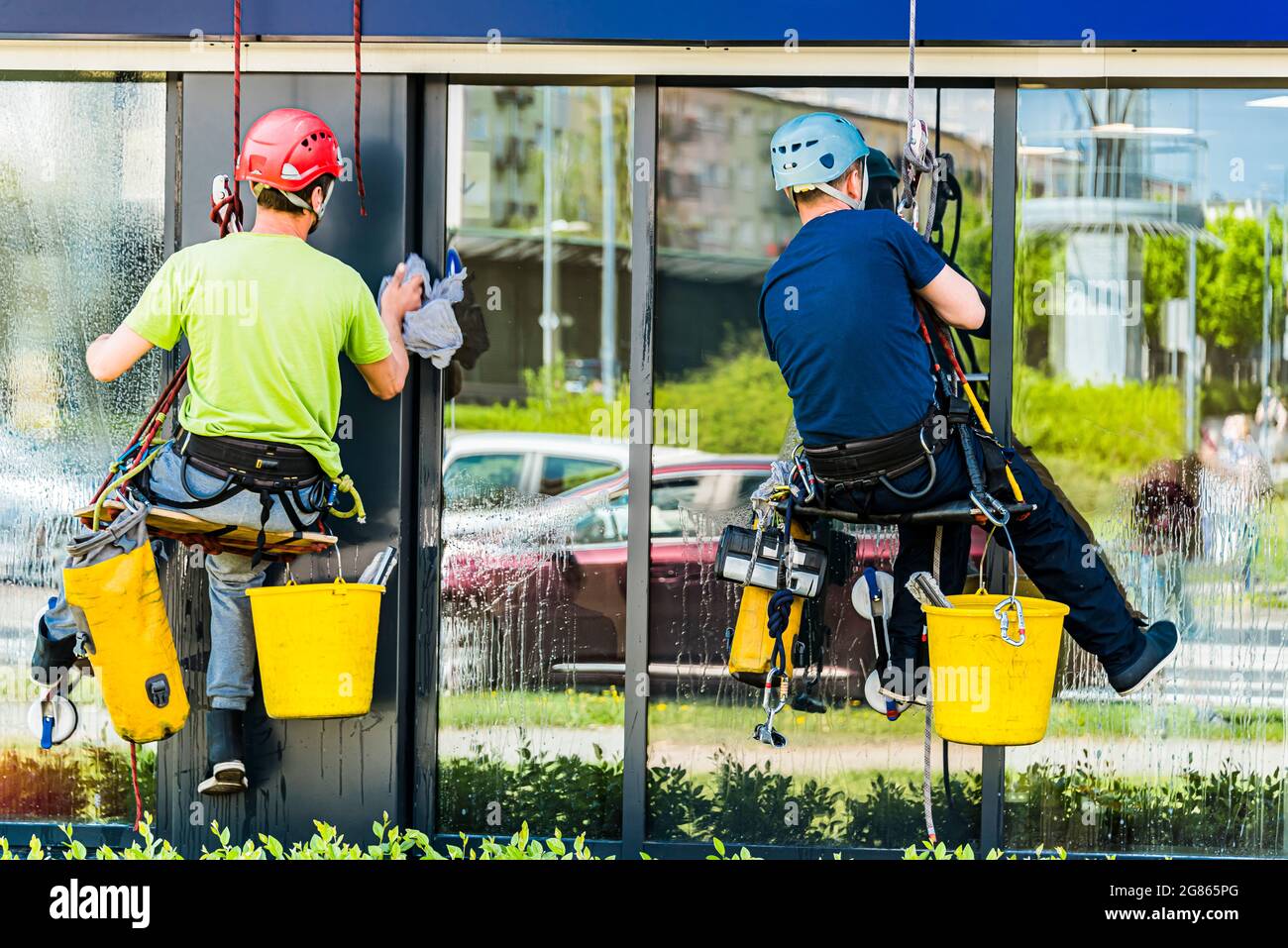 Two men cleaning windows on an office building Stock Photo - Alamy
