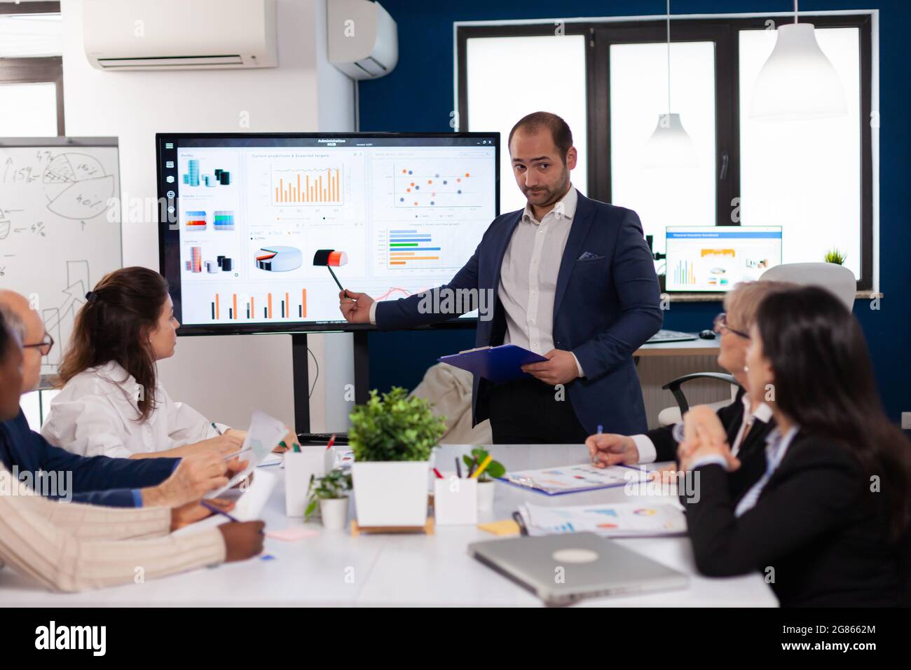 Successful team leader briefing pointing explaining project in ...
