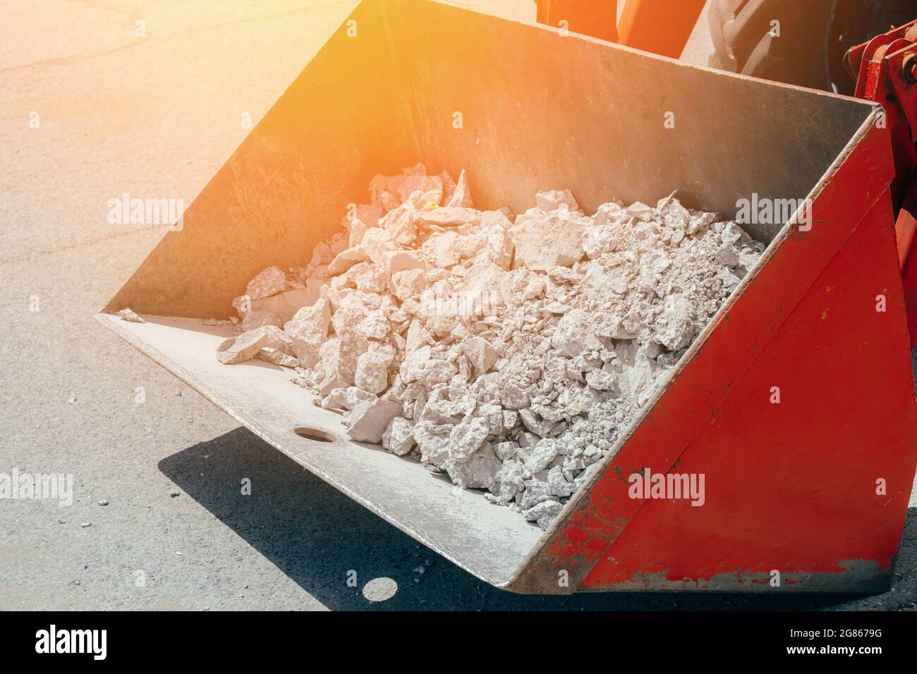 Removal of construction debris. The bucket of the tractor is filled ...