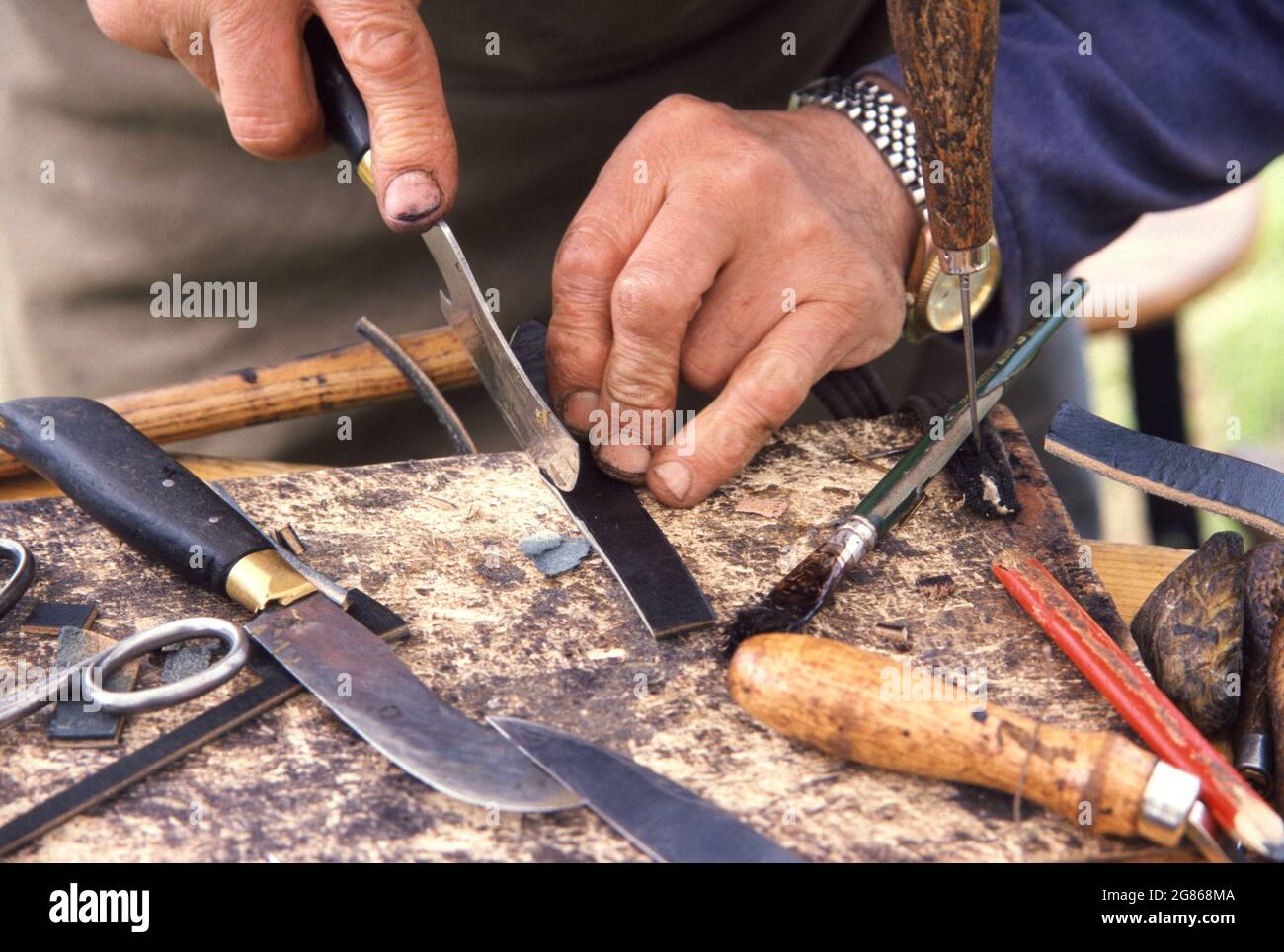 Handwork cutting leather and working with old tools Stock Photo - Alamy