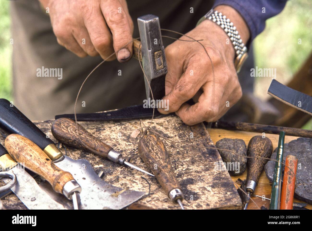 Handwork cutting leather and working with old tools Stock Photo - Alamy