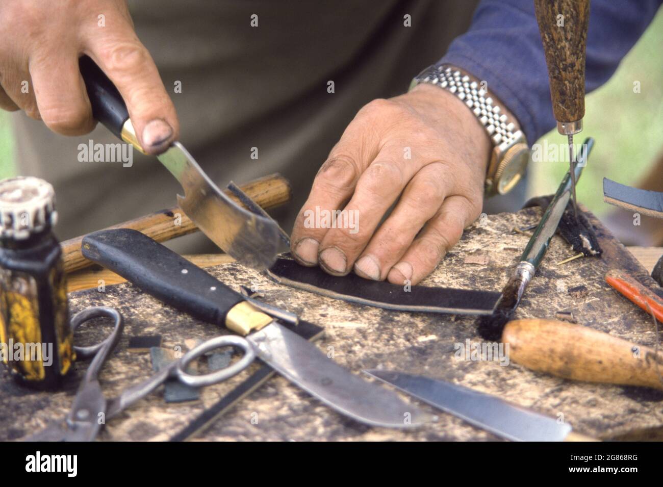 Handwork cutting leather and working with old tools Stock Photo - Alamy