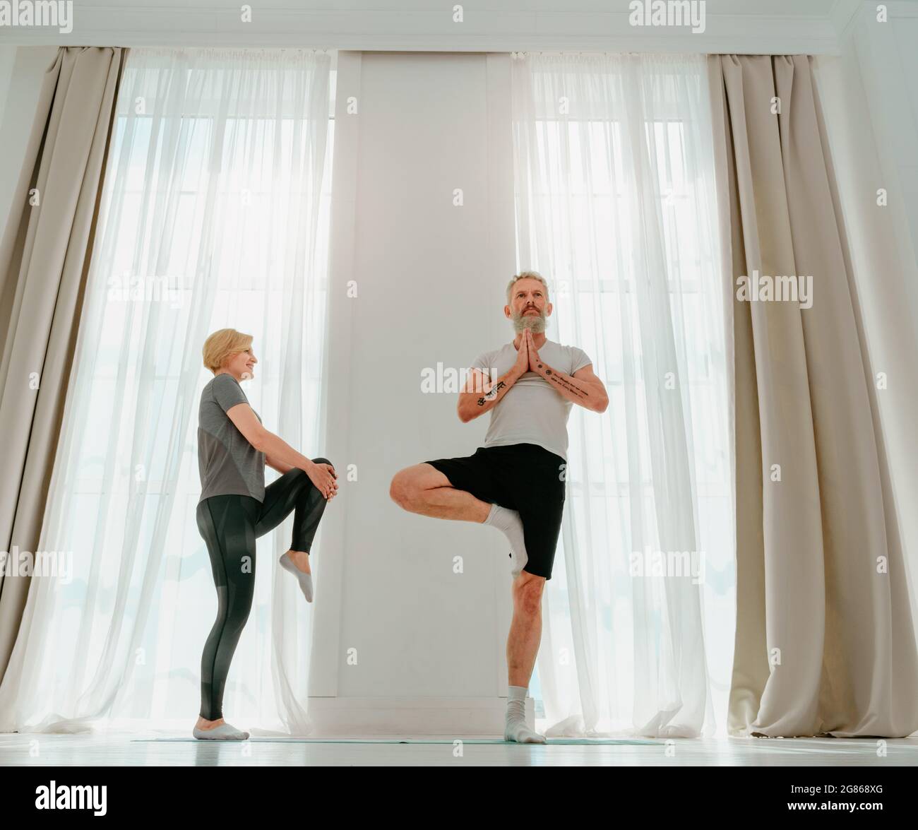 Husband and wife do yoga exercise together at home Stock Photo - Alamy