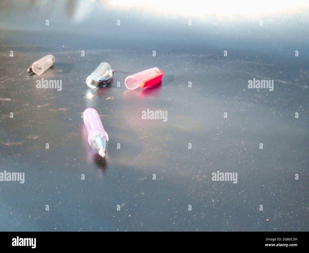 Ball pen presented with multiple caps at black surface Stock Photo - Alamy