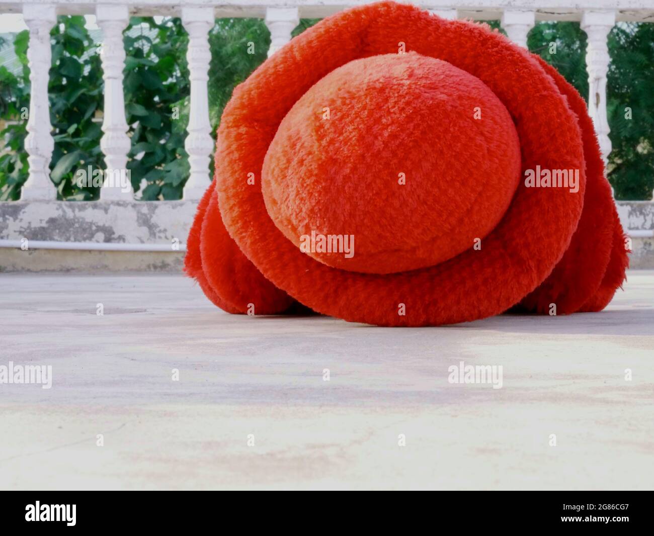 Teddy bear soft toy falling down on cemented floor, head focus shot ...