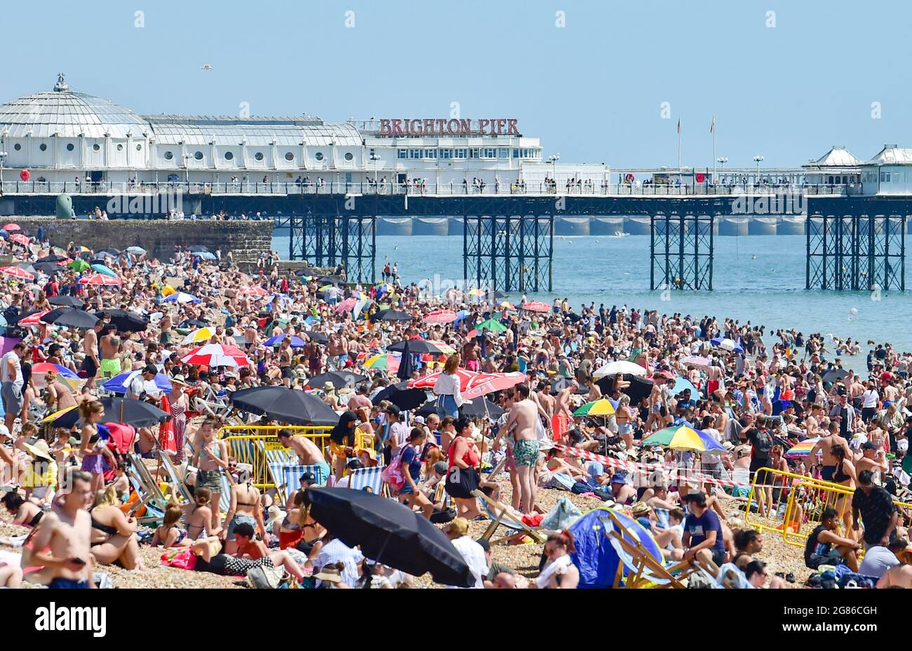 Brighton, UK. 17th July 2021. - Brighton beach and seafront are packed ...