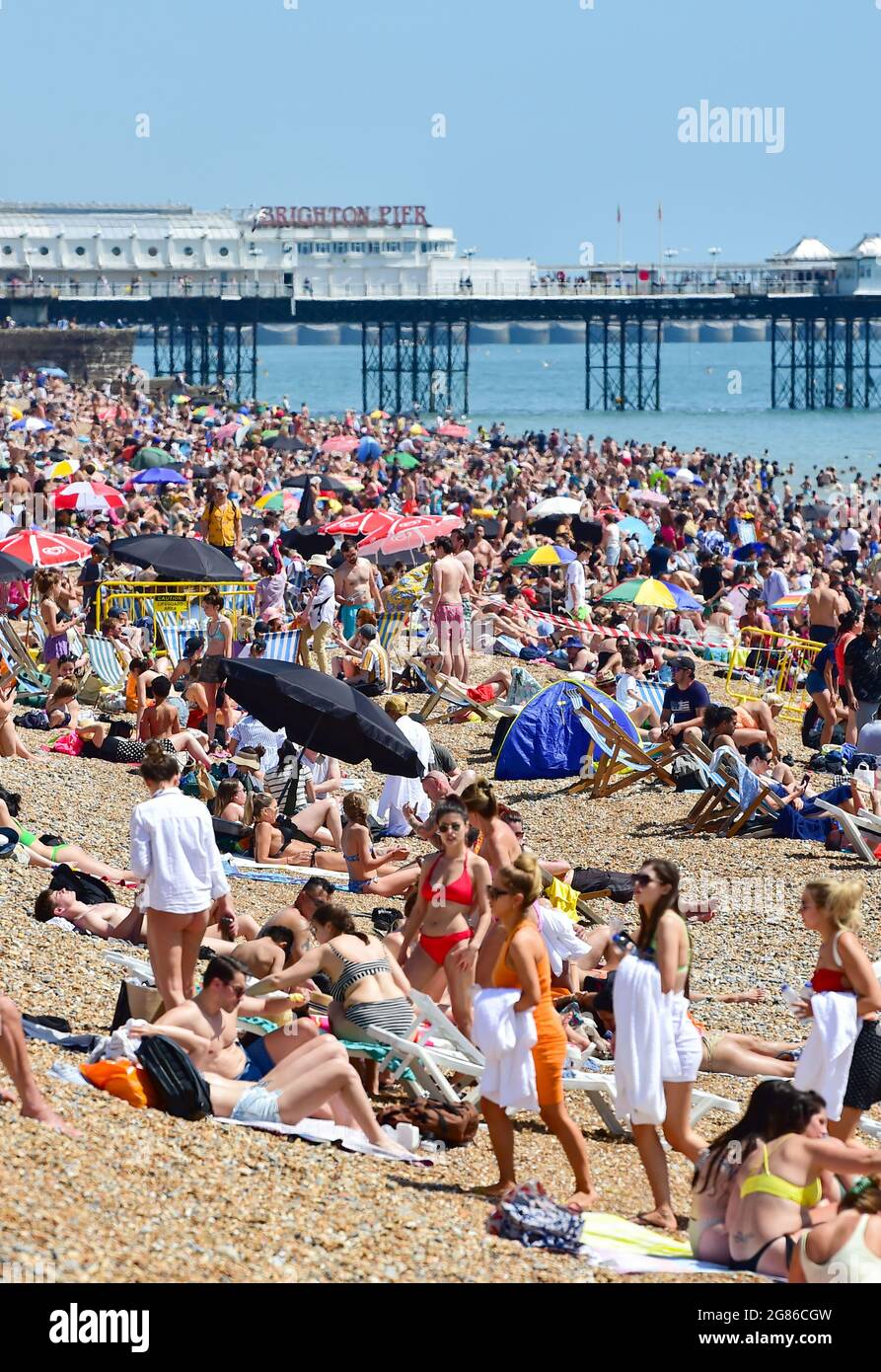 Brighton, UK. 17th July 2021. - Brighton beach and seafront are packed ...