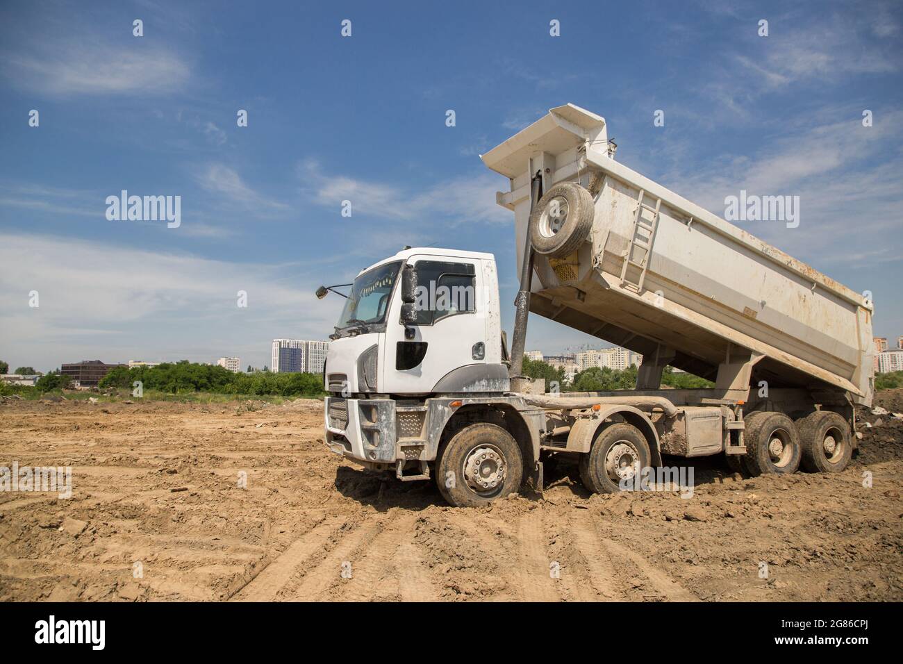 dump truck at work at a construction site. The process of transporting ...