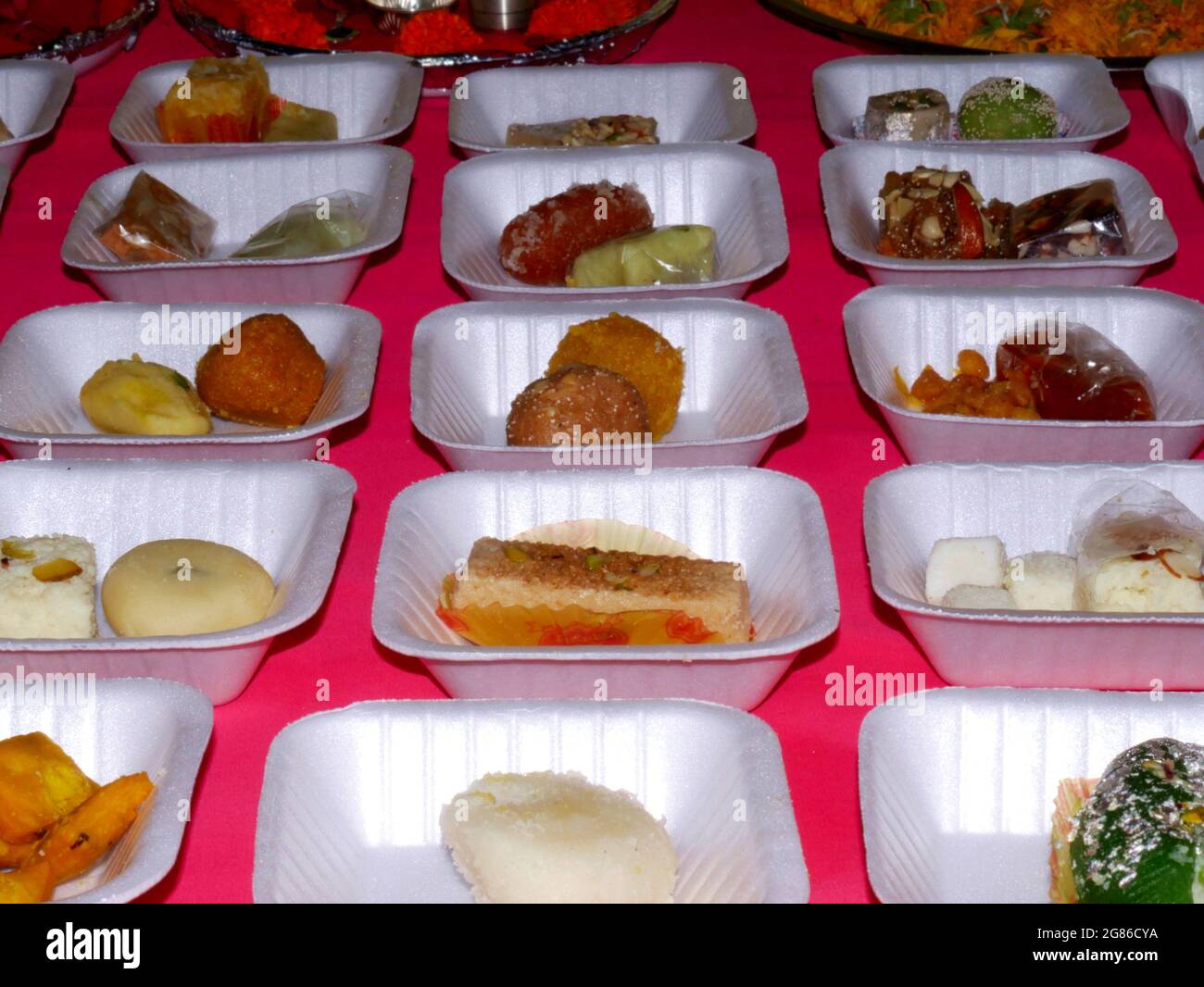 Collection of Indian traditional sweets presented on white color ...