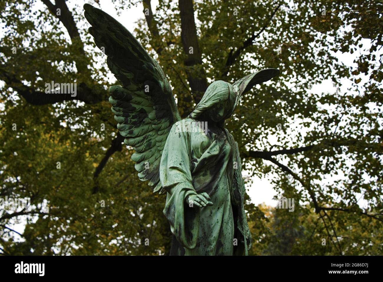 Grieving angel statue in the middle of a graveyard in Berlin Stock ...