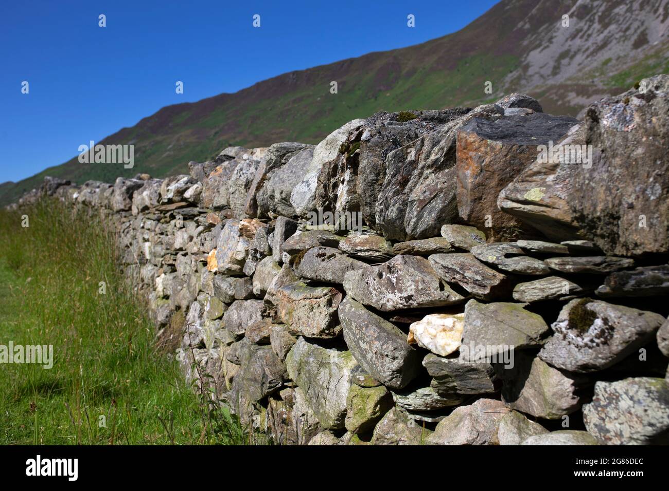 Traditional sry stone wall on farmland in the Welsh mountains. On a ...