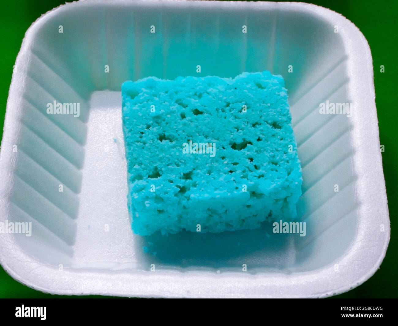 Asian traditional blue sweet made with gram flour kept on white ...