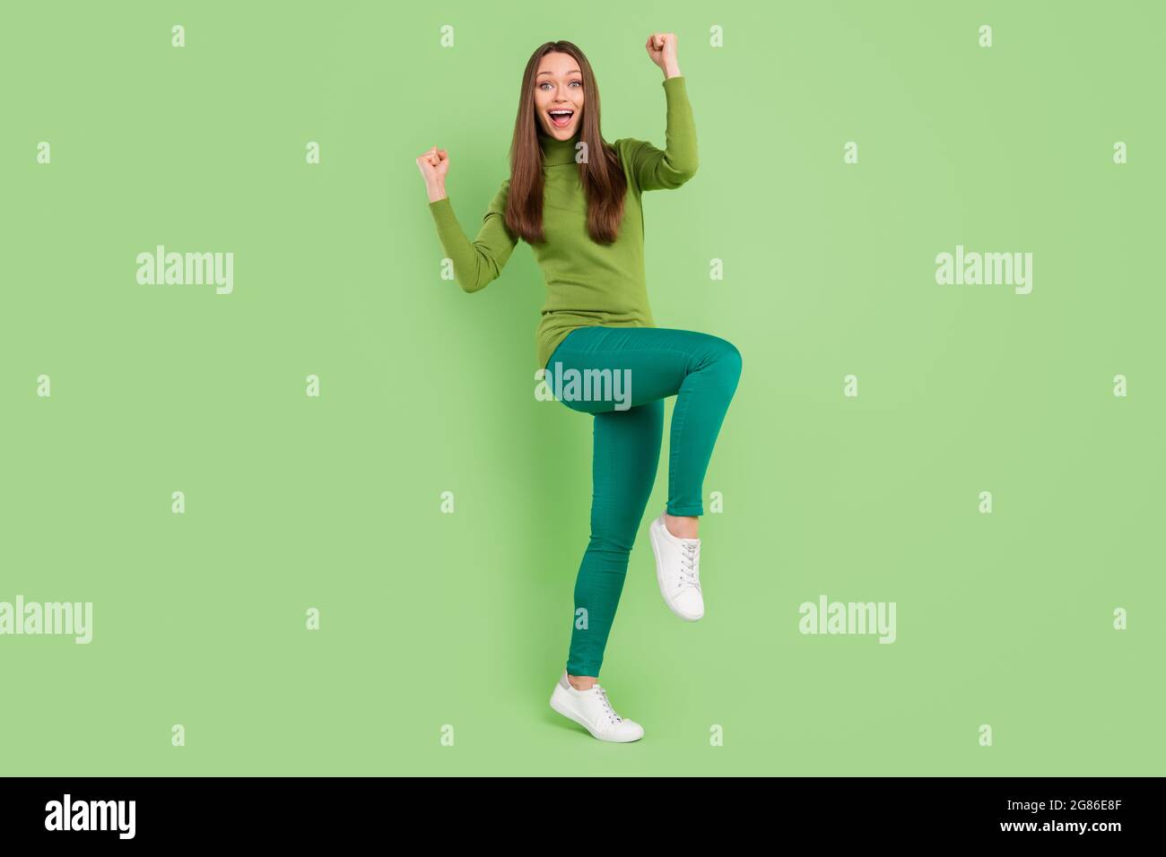 Full body photo of attractive young nice lady good mood raise fists ...