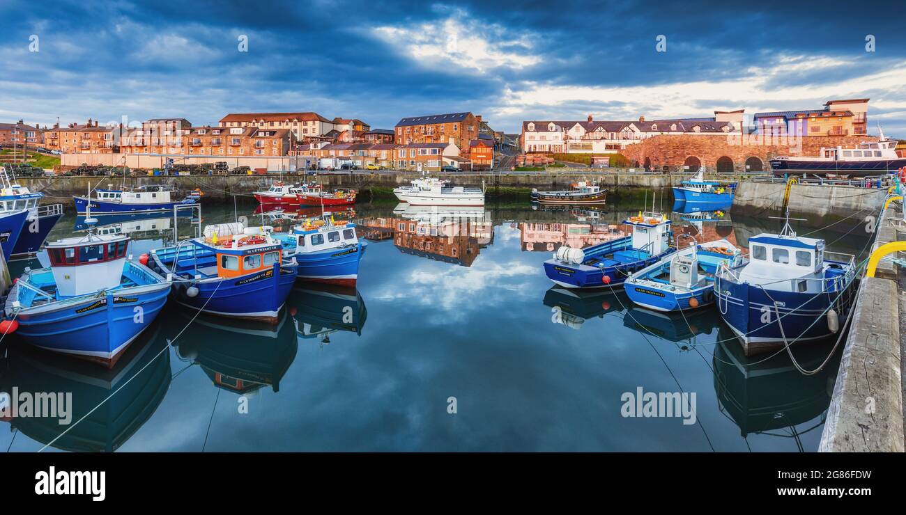 A lovely still morning with the colourful boats reflected in the ...
