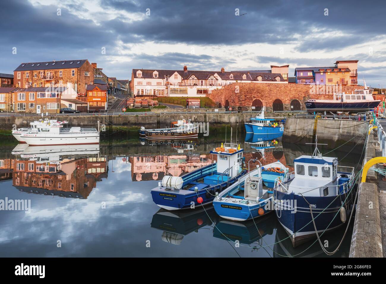 A lovely still morning with the colourful boats reflected in the ...