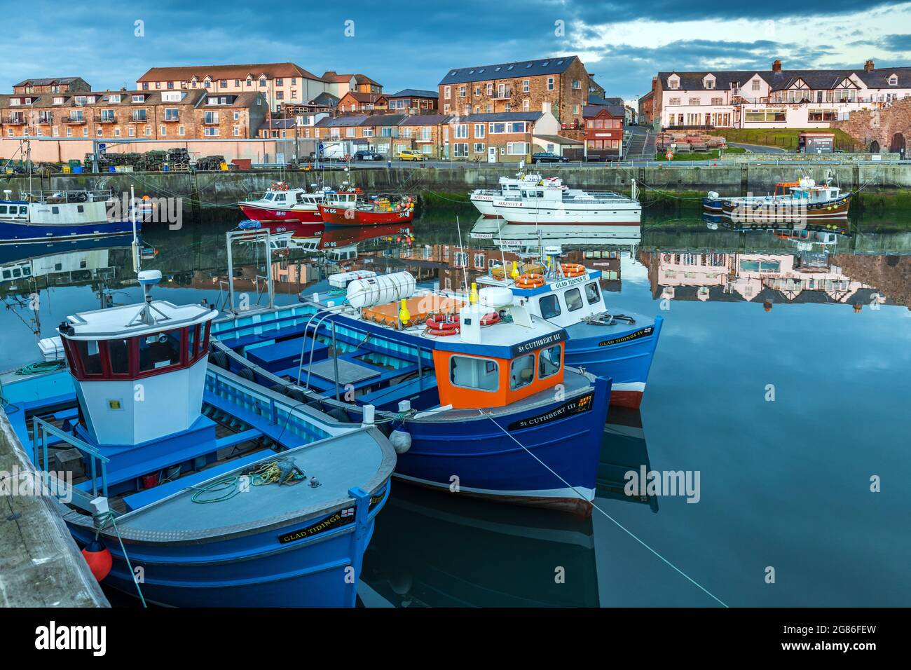 A lovely still morning with the colourful boats reflected in the ...