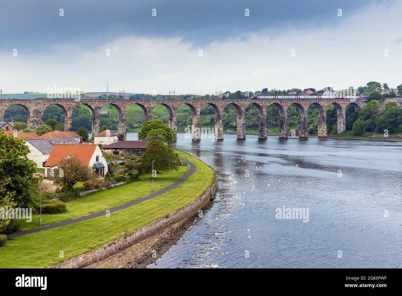 A train crossing the Royal Border Bridge over the river Tweed at ...