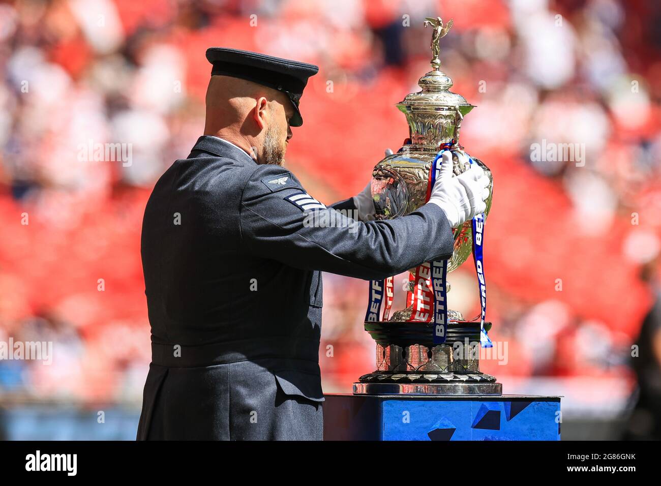 A serviceman places The Betfred Challenge trophy onto at stand on the ...