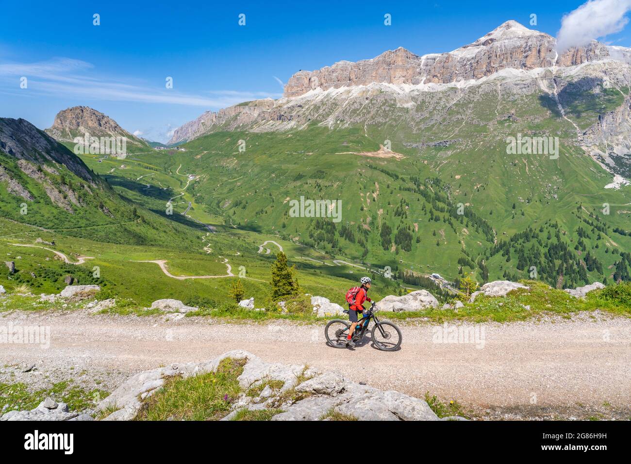 active senior woman riding the famous Sella Ronda mountain bike Trail ...