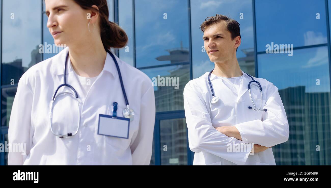 young excited doctors standing outside the hospital building Stock ...