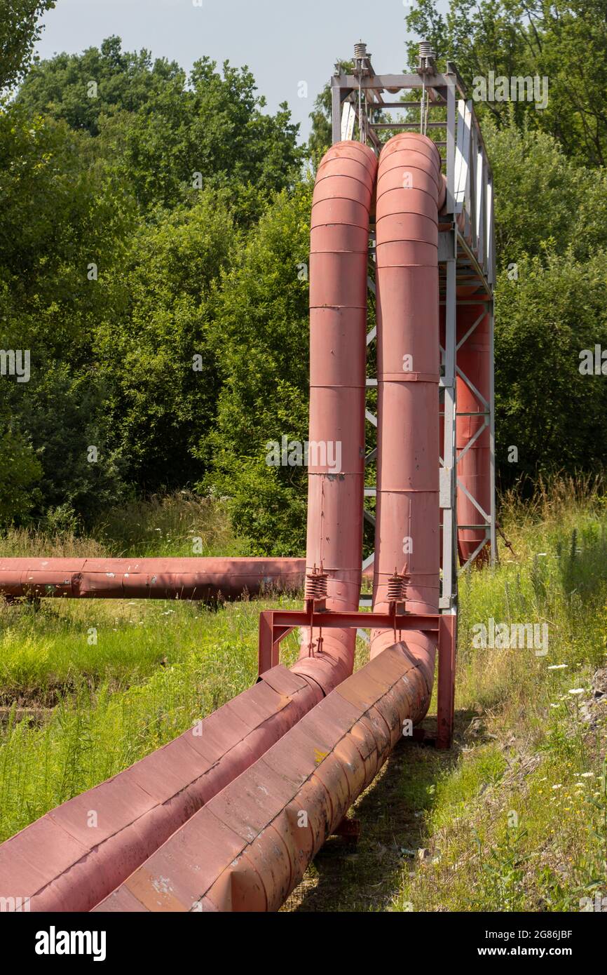 Hot water - steam pipes with bridging in summer nature Stock Photo - Alamy
