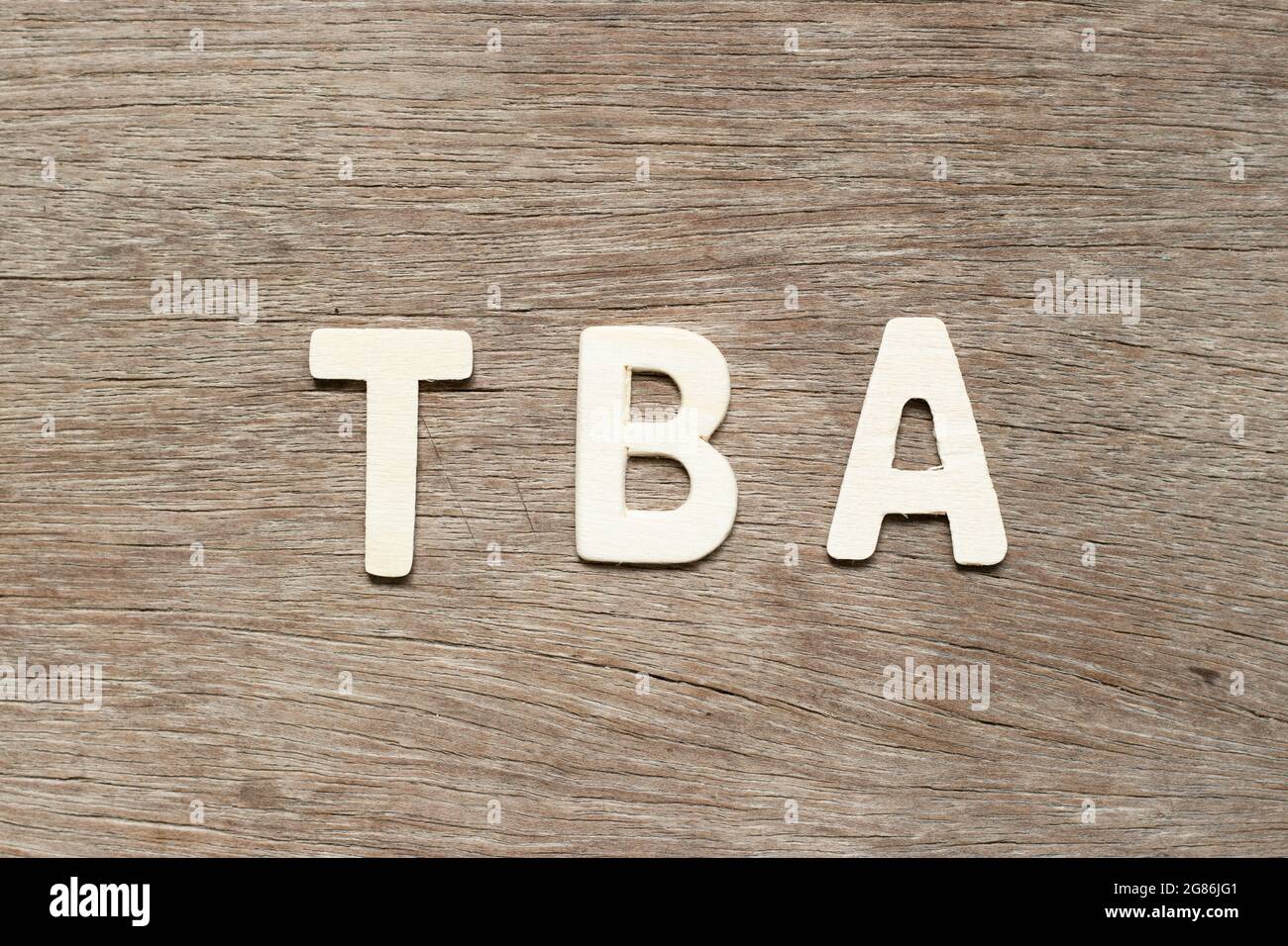 Alphabet letter in word TBA (abbreviation of to be announced) on wood ...