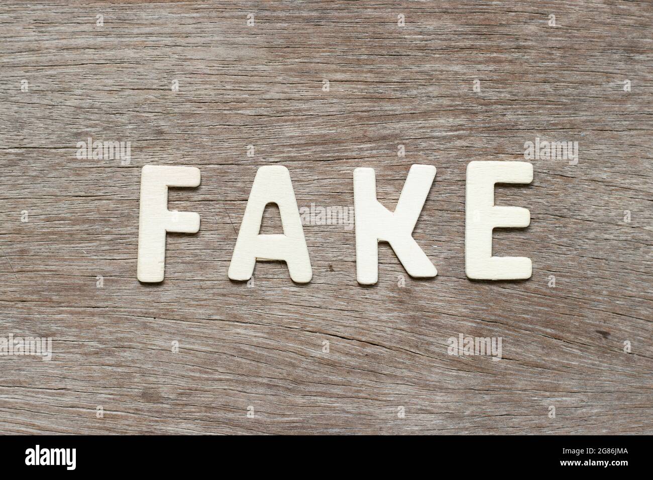 Alphabet letter in word fake on wood background Stock Photo - Alamy