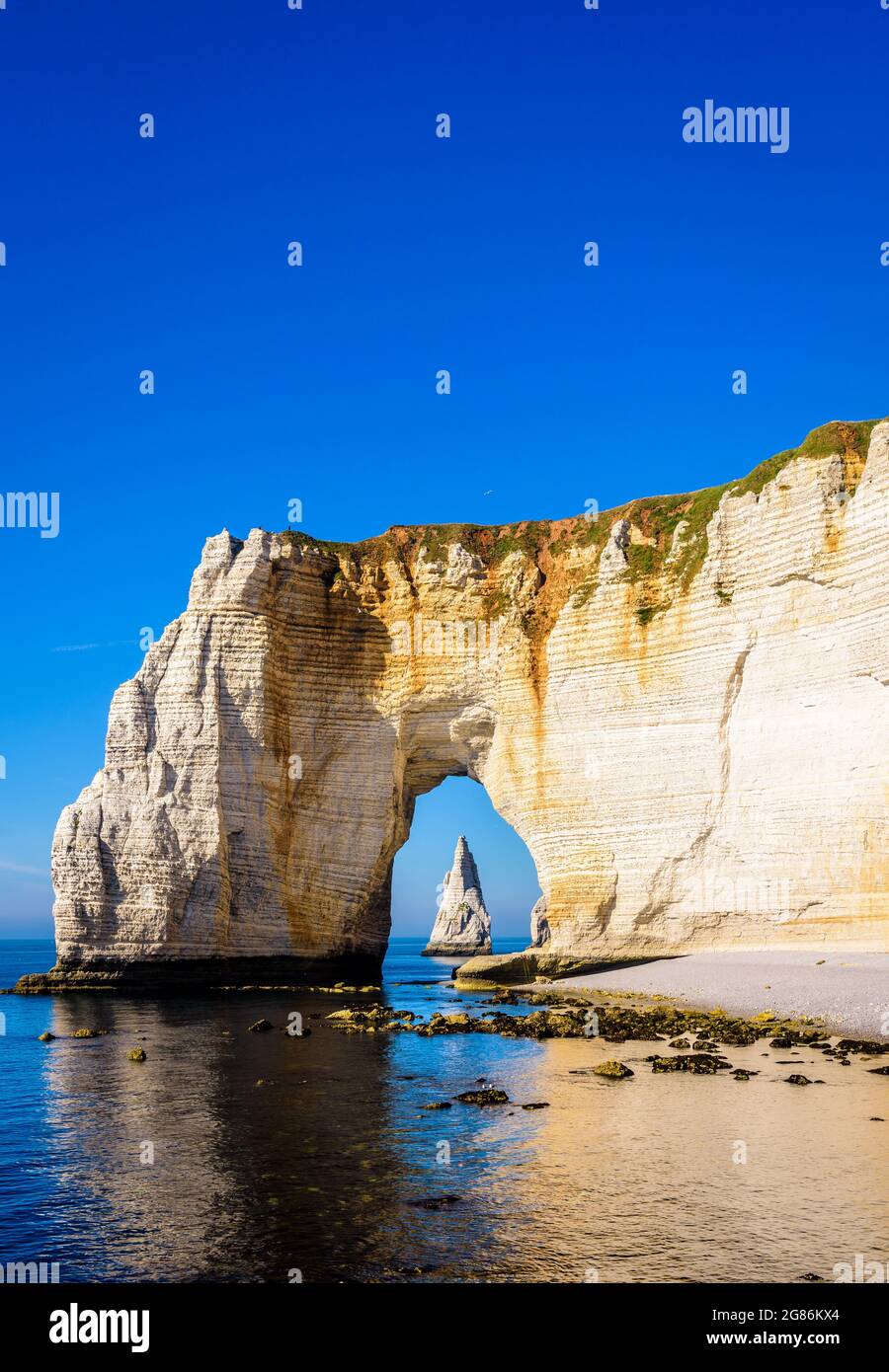The Needle seen through the arch of the Manneporte cliff in Etretat ...