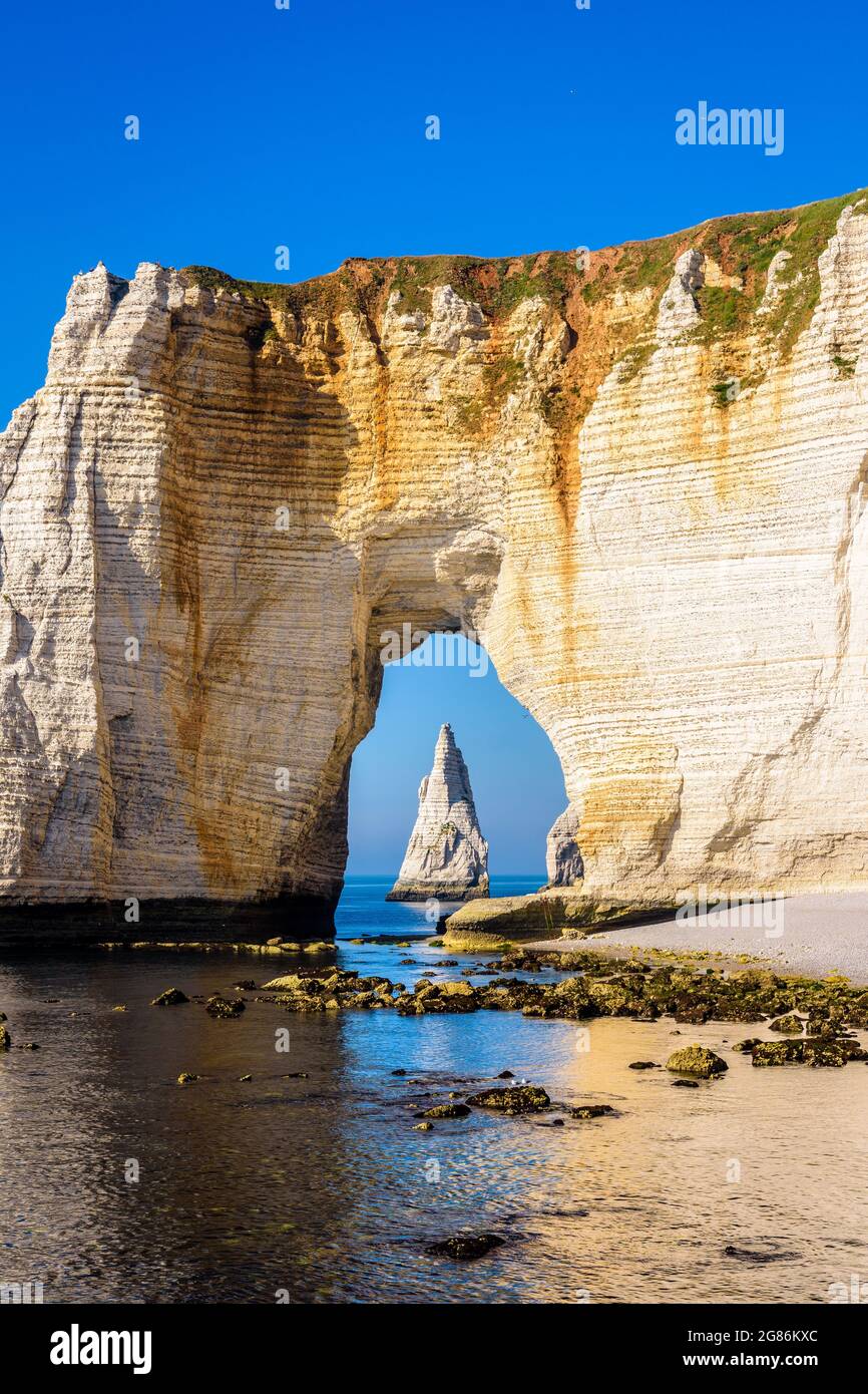 The Needle seen through the arch of the Manneporte cliff in Etretat ...