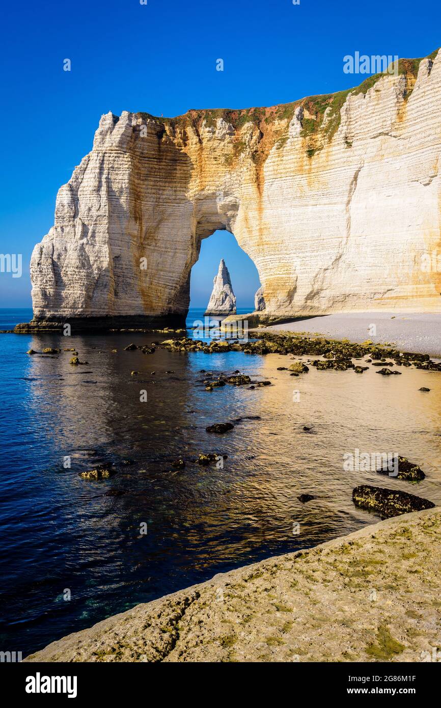 The Needle seen through the arch of the Manneporte cliff in Etretat ...