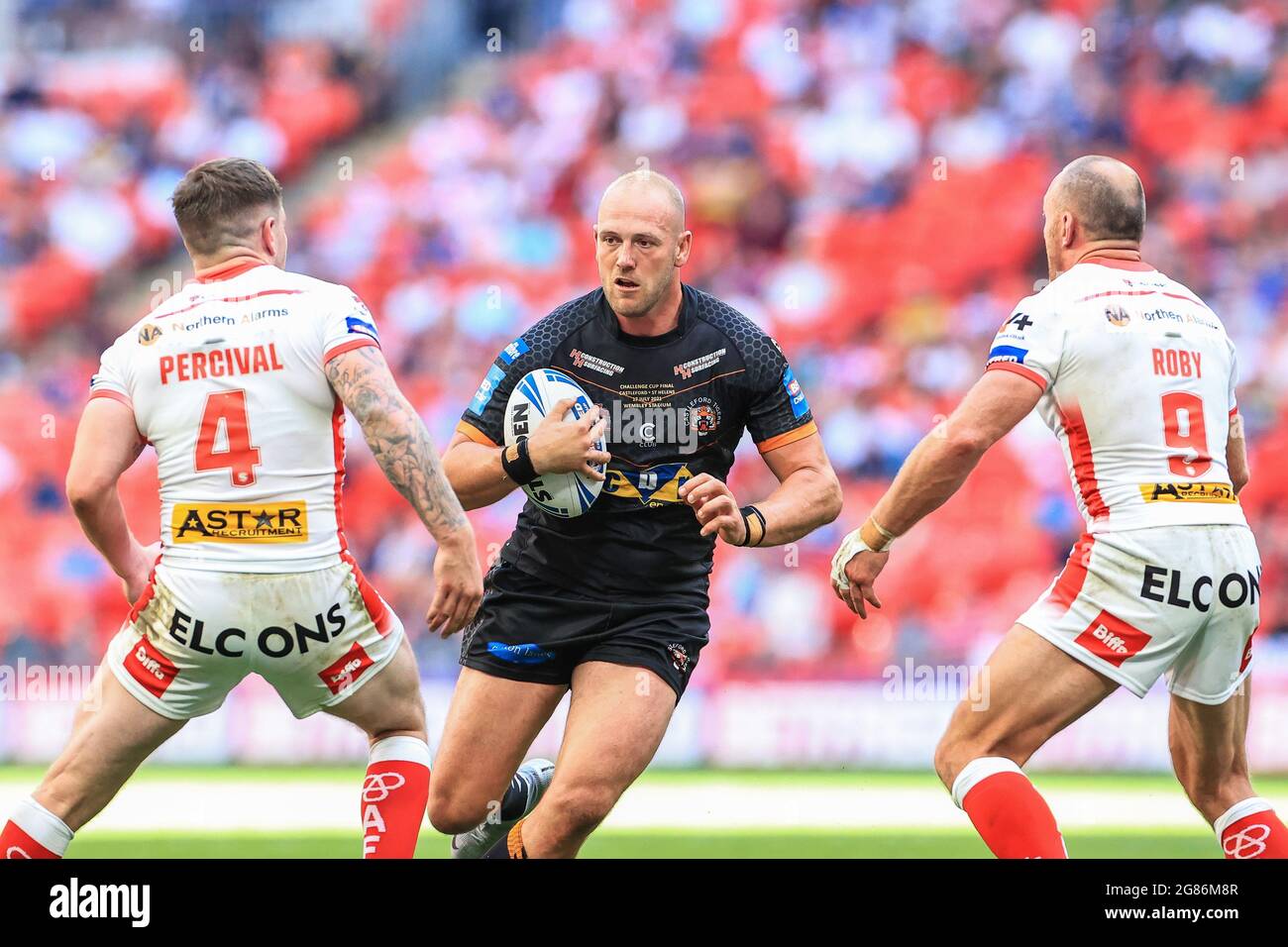 Liam Watts (8) of Castleford Tigers looks for a way past James Roby (9 ...