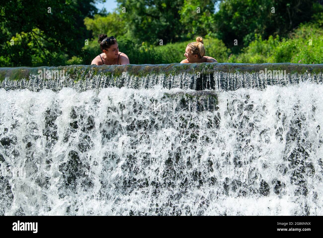 People enjoy the water at Warleigh Weir on the River Avon near Bath in ...