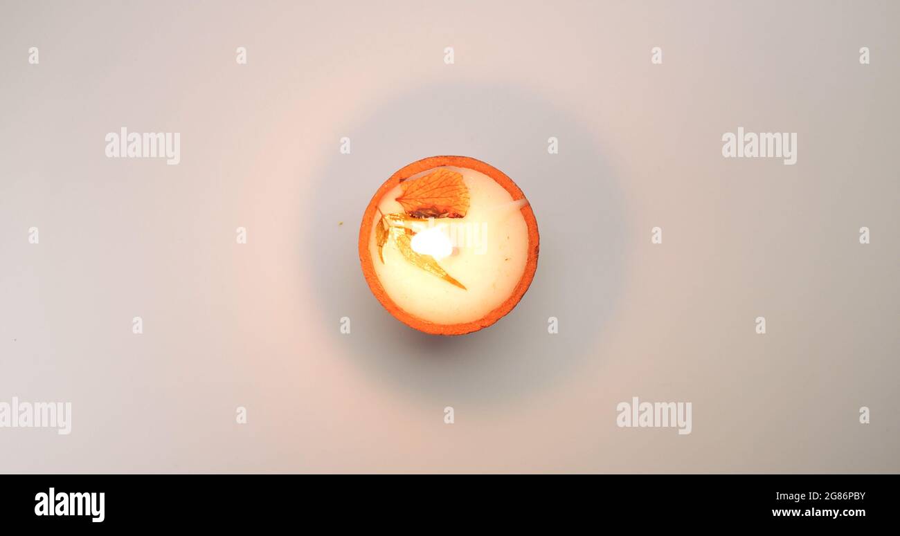 Top view of a burning candle in the light background; Diwali festival ...