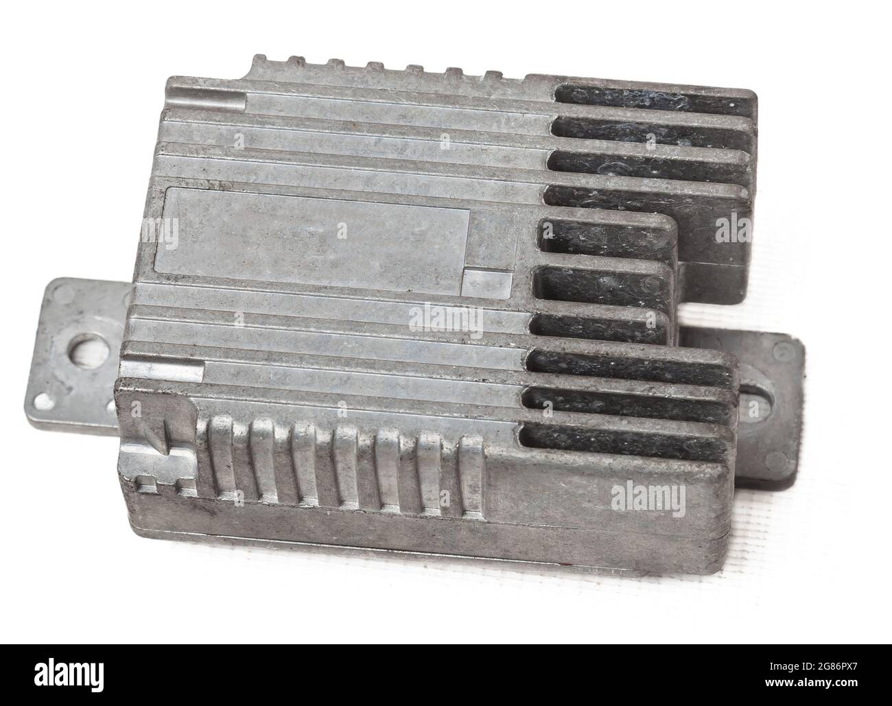 Metallic car engine control unit with plastic elements on a white ...