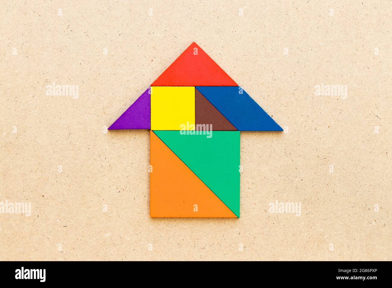 Color tangram puzzle in home or arrow shape on wood background Stock ...