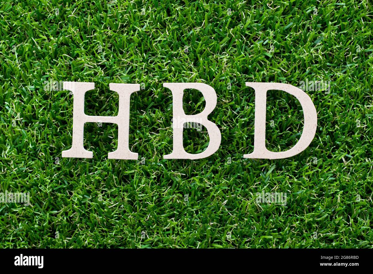 Wood letter in word HBD (Abbreviation of happy birthday) on artificial ...