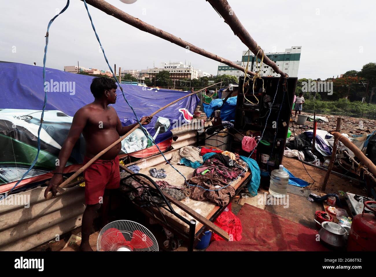 Chennai, Tamil Nadu, India. 17th July, 2021. A man in a slum area ...