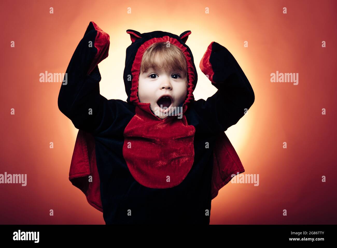 Holiday halloween with funny carnival costumes on red background. The ...