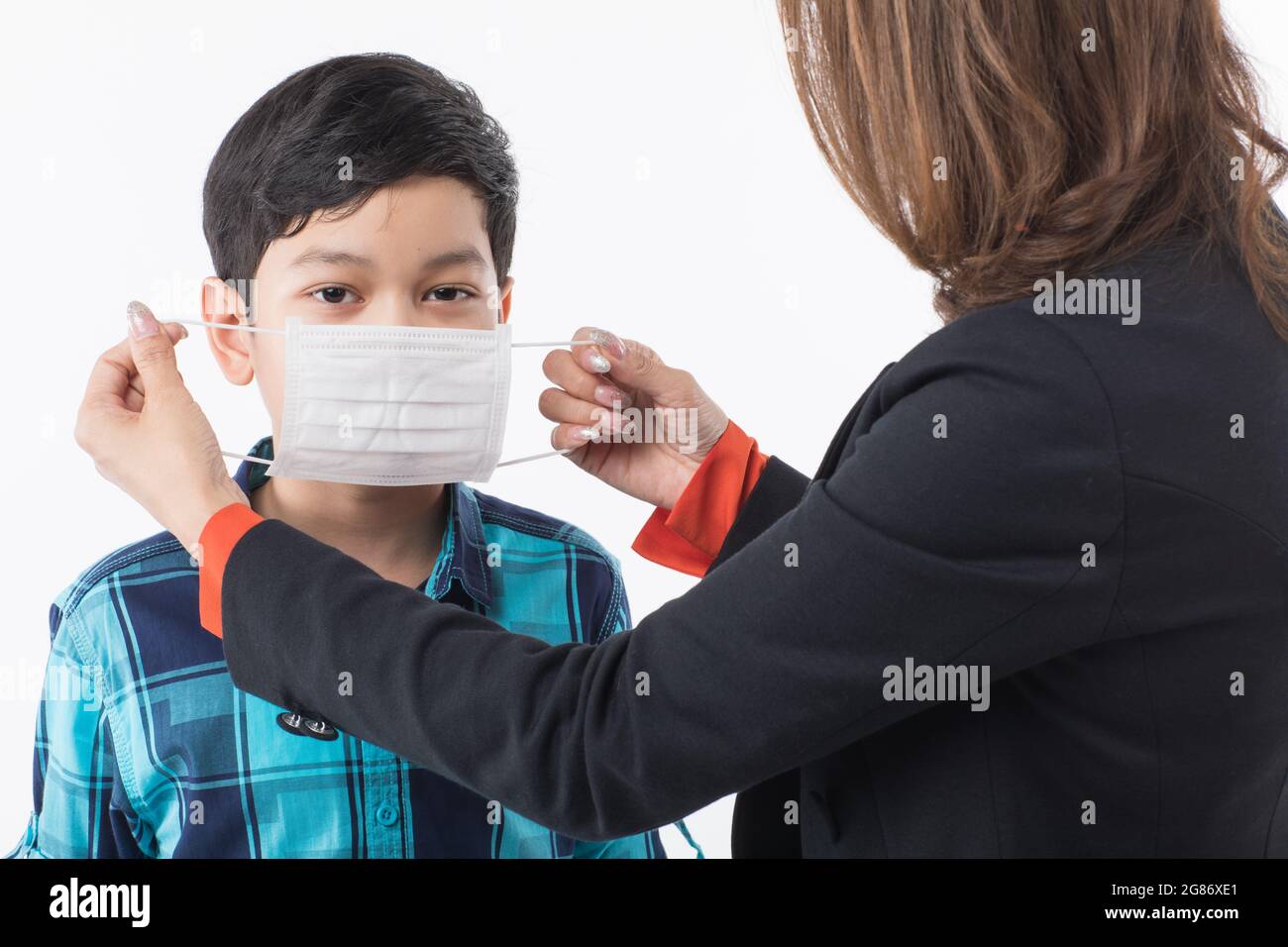 Mother wearing surgical protective mask on face of son kid. Idea for ...