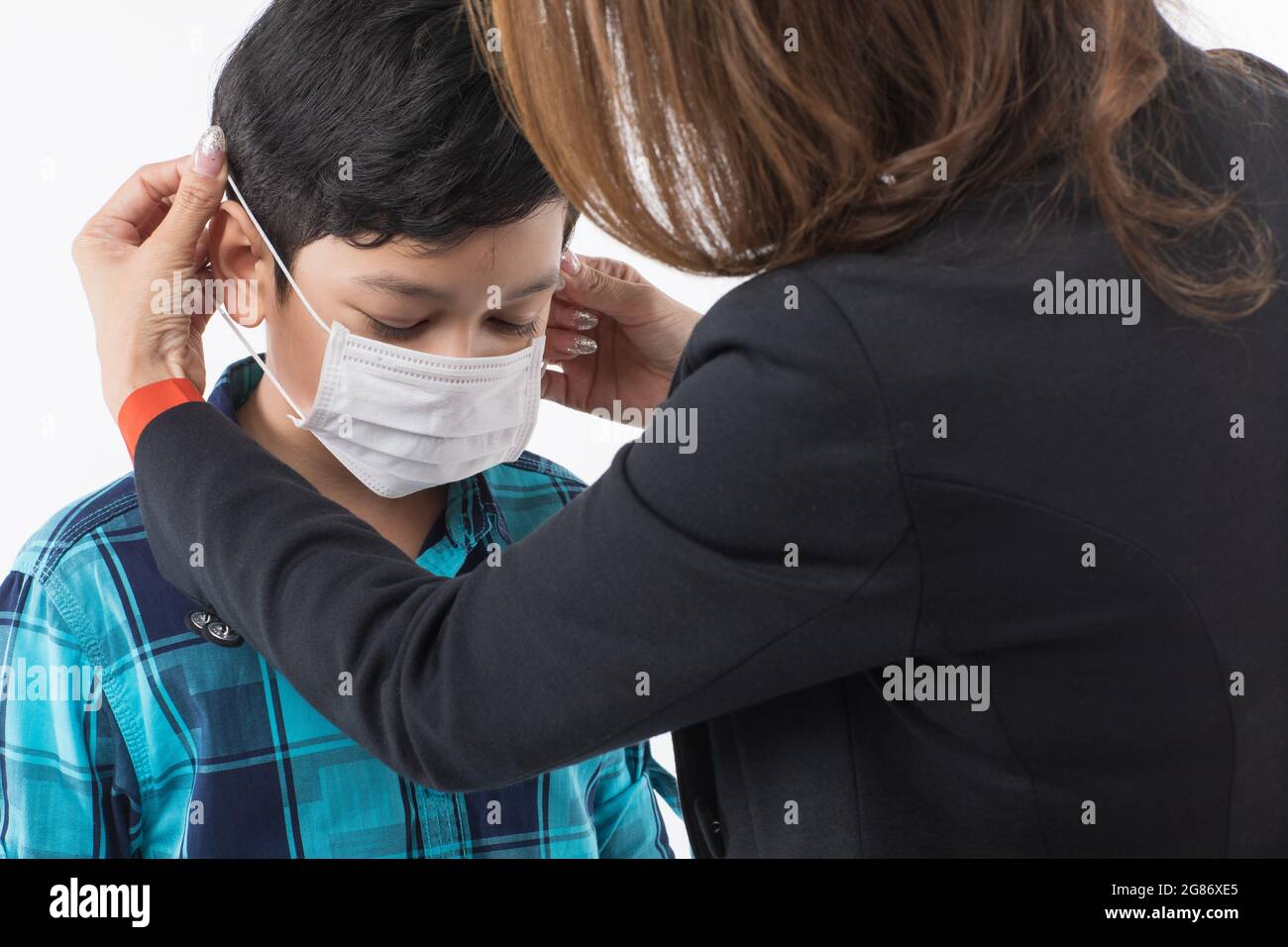 Mother wearing surgical protective mask on face of son kid. Idea for ...
