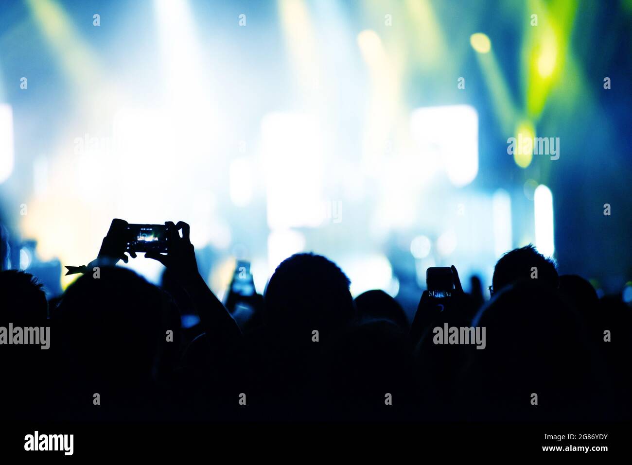 Silhouette of hands recording a concert with smart phones. Crowd of ...