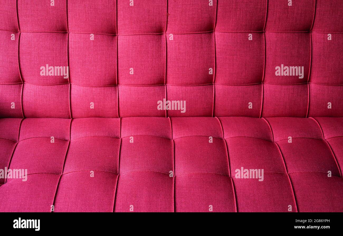 Texture details of red cover soft cotton cloth fine sewing sofa. Fabric ...