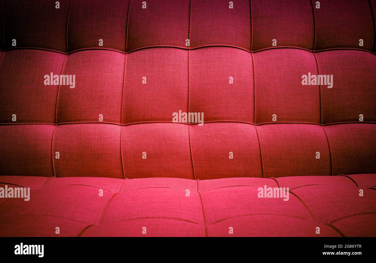 Texture details of red cover soft cotton cloth fine sewing sofa. Fabric ...