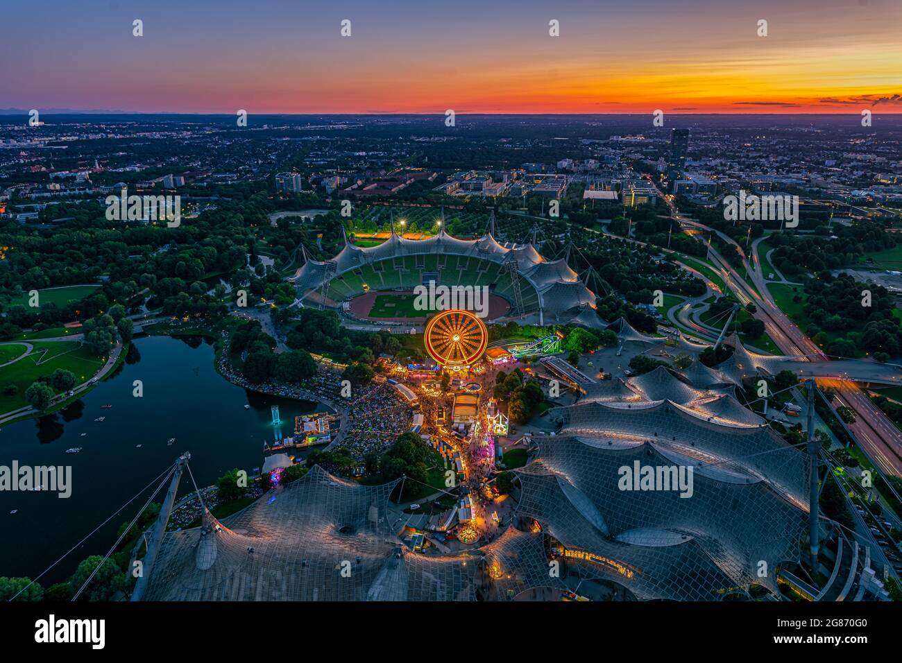 Wonderful Munich sunset from a high view with a festival at the popular ...