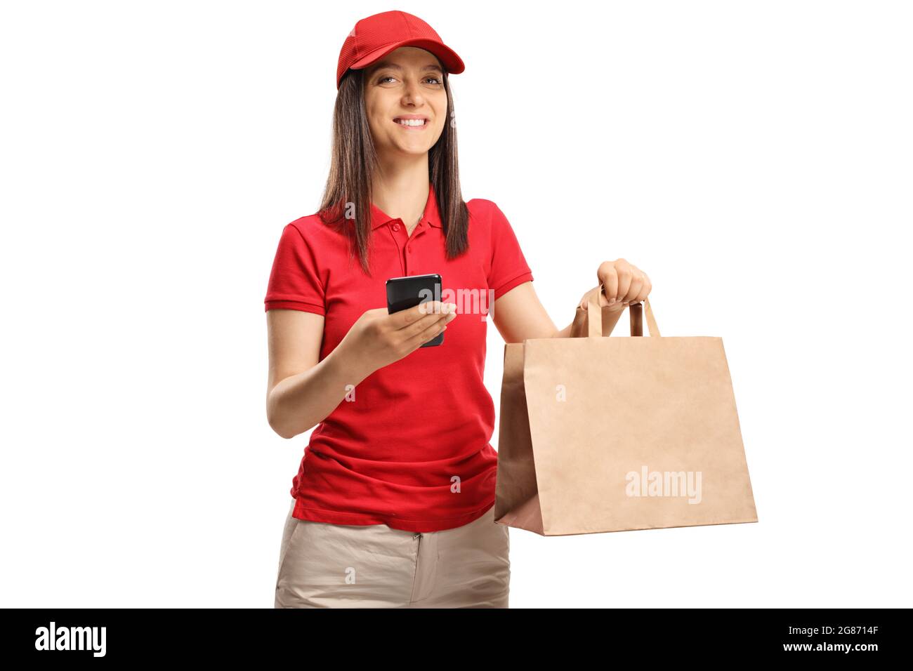 Fast food delivery girl with a paper bag and a mobile phone isolated on ...