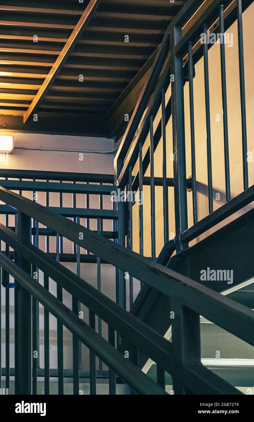 Railings and steps in a stair well create an abstract design Stock ...